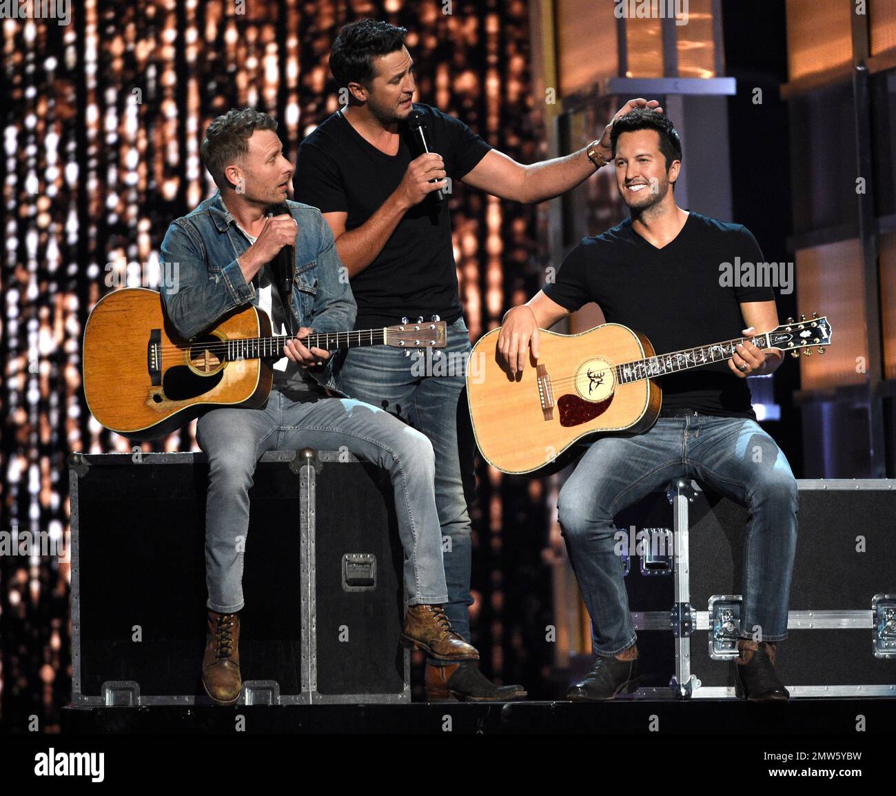 Dierks Bentley, from left, and Luke Bryan interact with a wax figure of ...