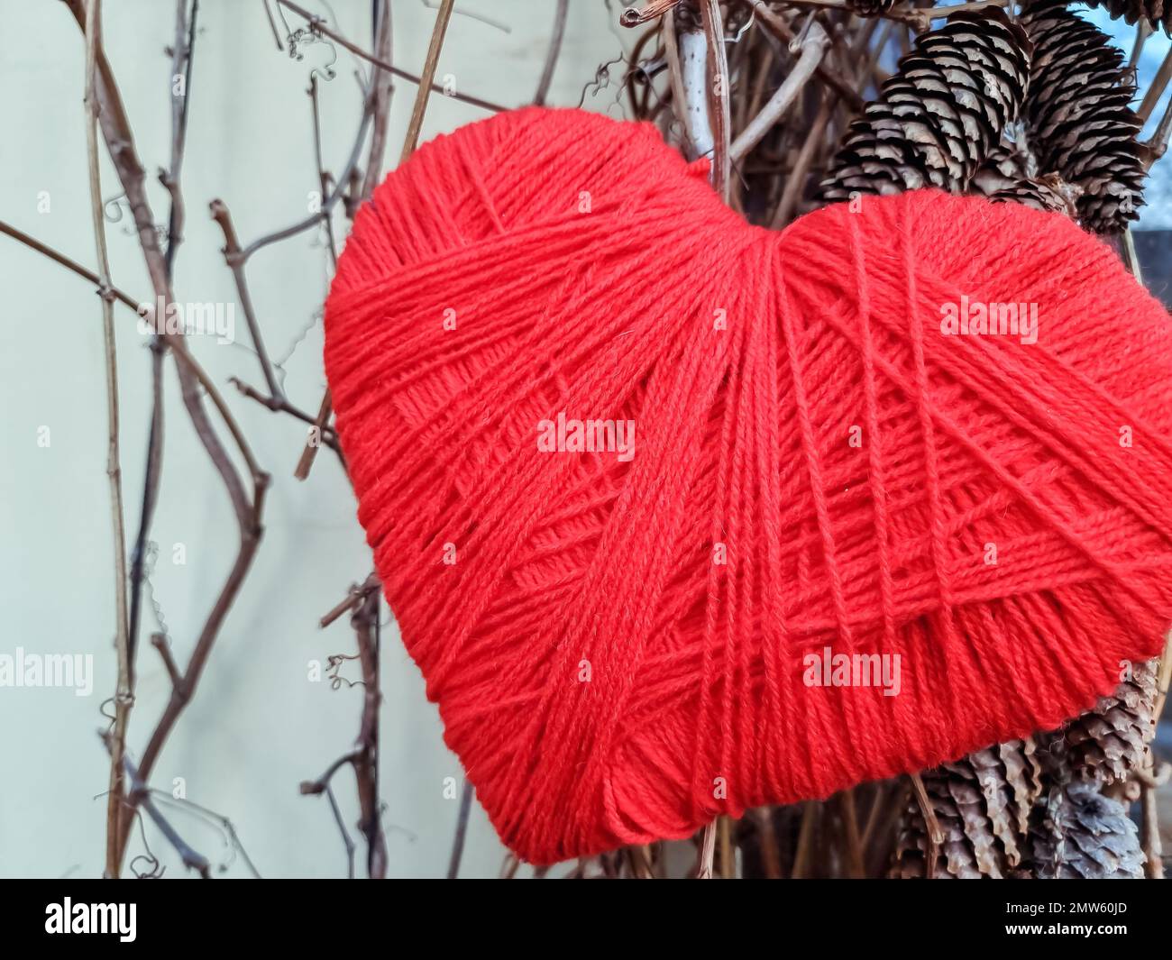 Red heart shape symbol made from wool isolated on white background ...