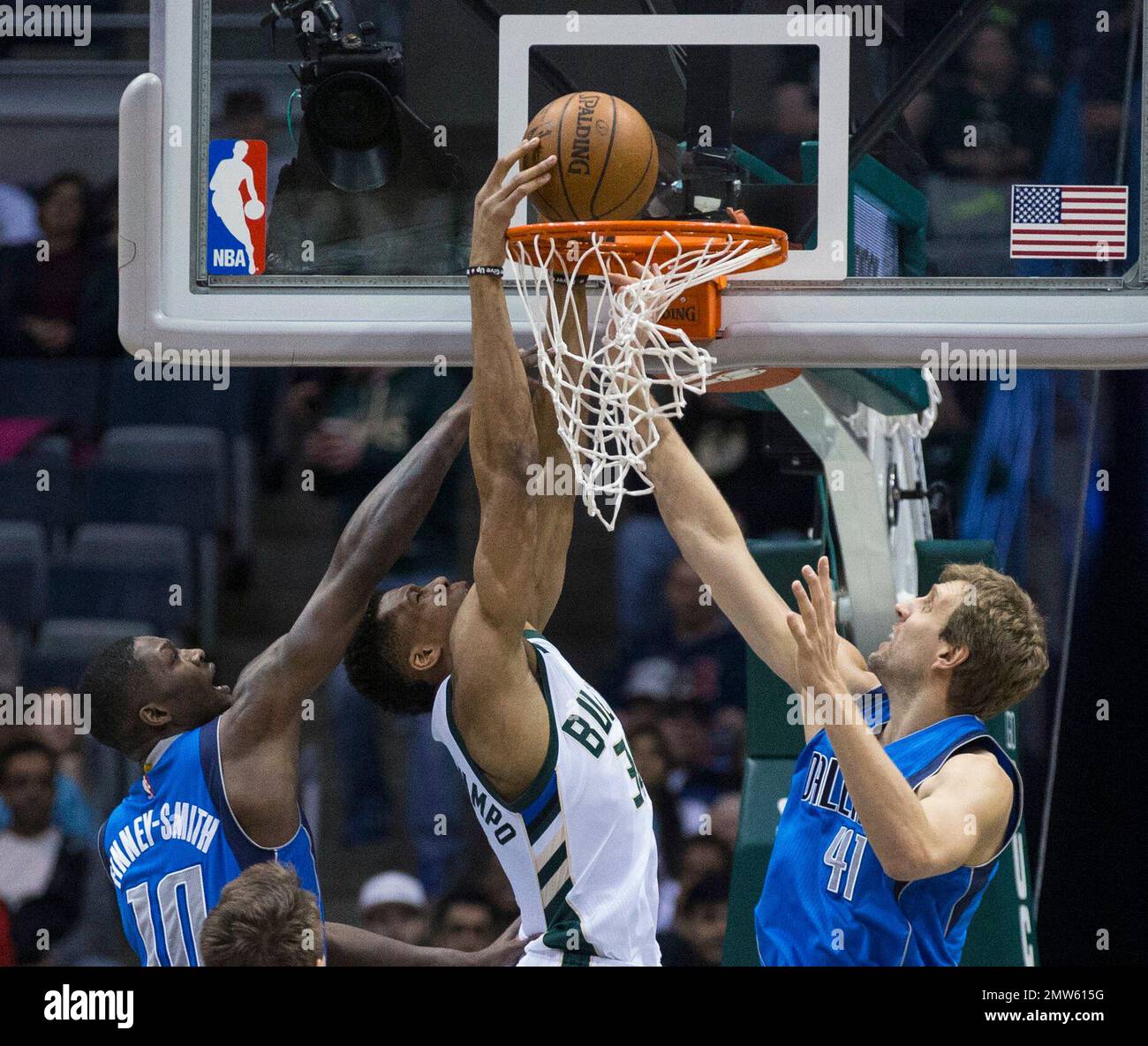 Milwaukee Bucks' Giannis Antetokounmpo, middle, dunks between Dallas ...