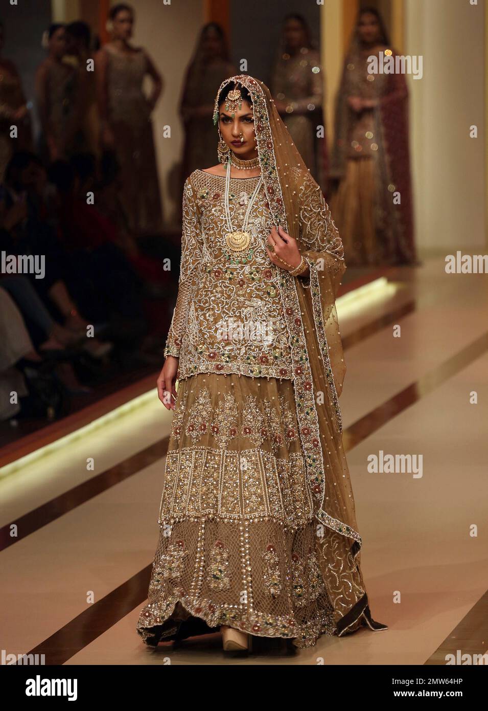 A Pakistani model presents creations by designer Faika Karim during the ...