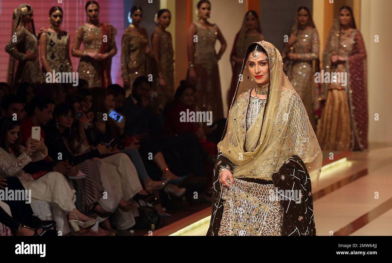 A Pakistani model presents creations by designer Faika Karim during the ...