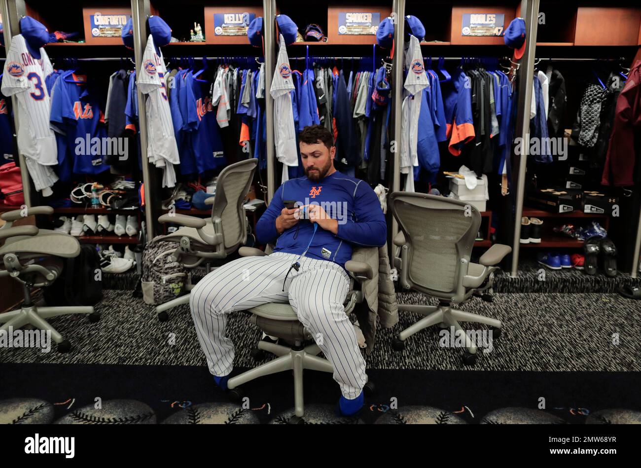 New York Mets relief pitcher Josh Smoker relaxes in front of his locker ...