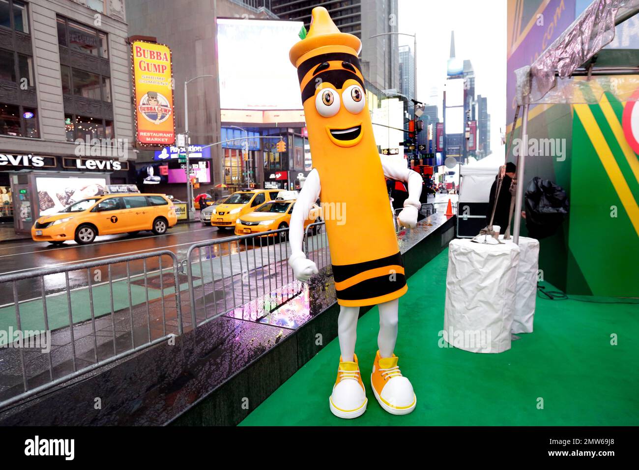 A dandelion crayon character poses for photos during a Crayola event in ...