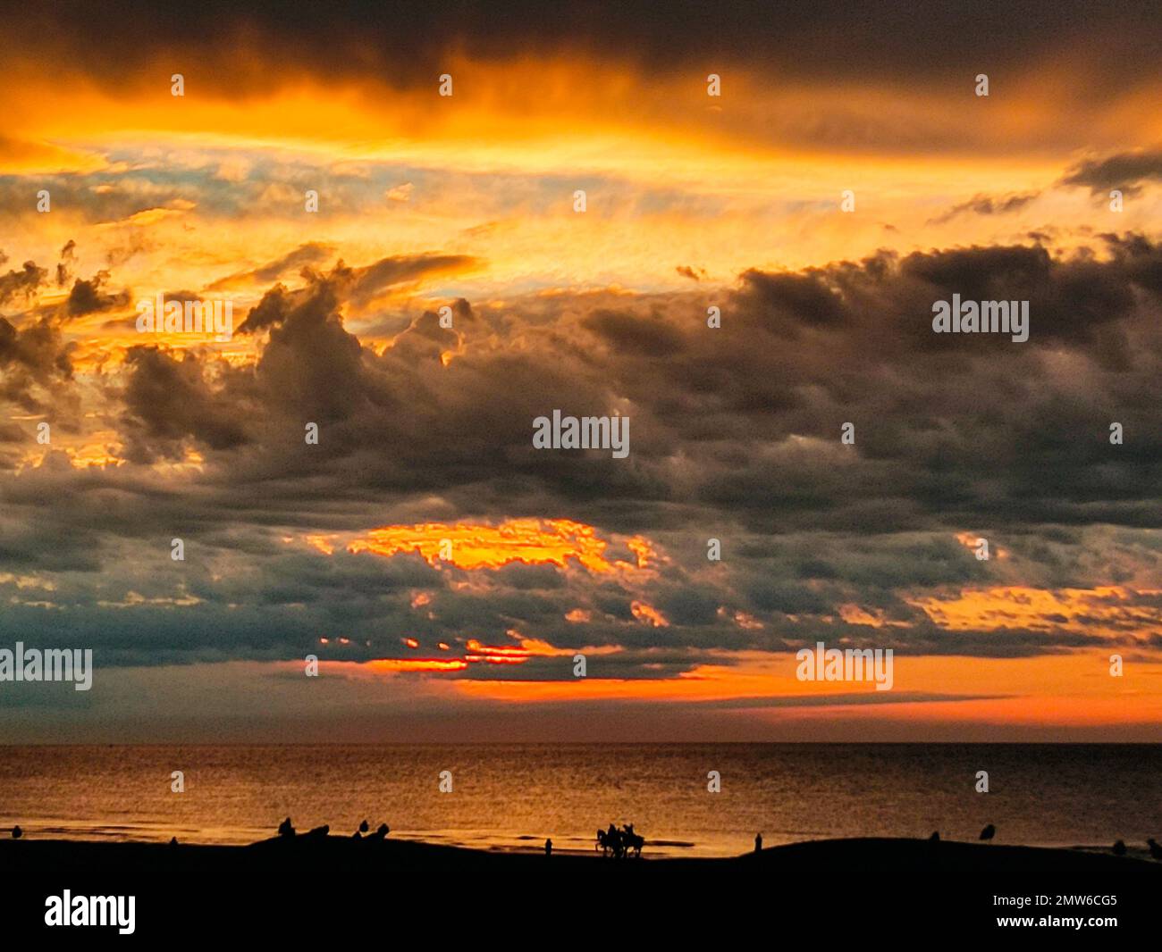 Dramatic sunset over Nieuwpoort sea ocean coast beach with silhouette ...
