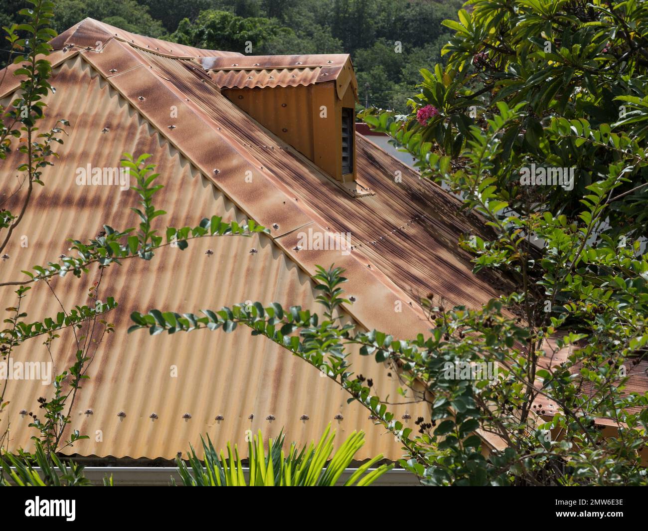 a close up view of rusty rust brown corrugated metal roof with dormer ...
