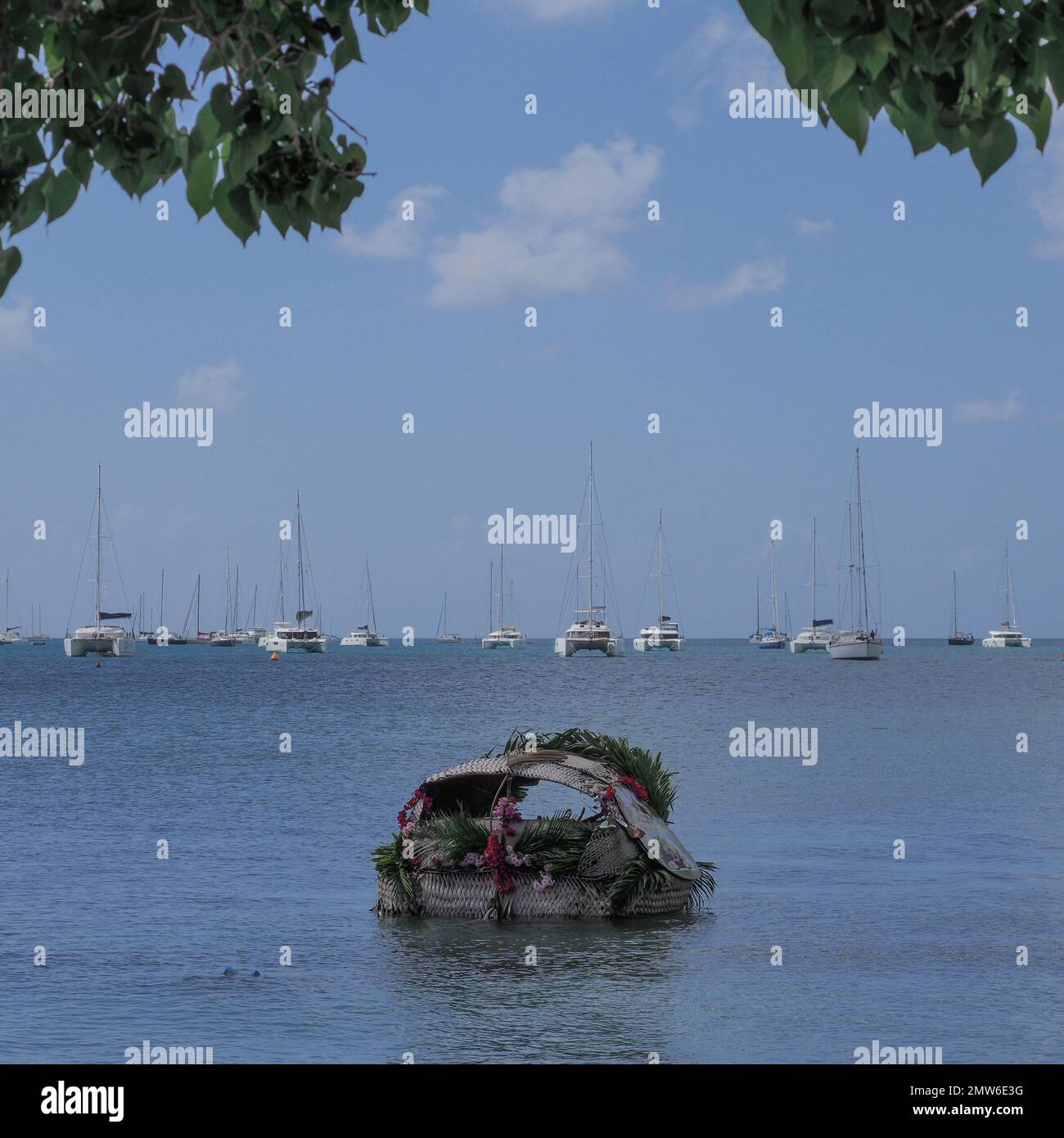a view of floating palm boat woven basket shrine on sea ocean anchored ...