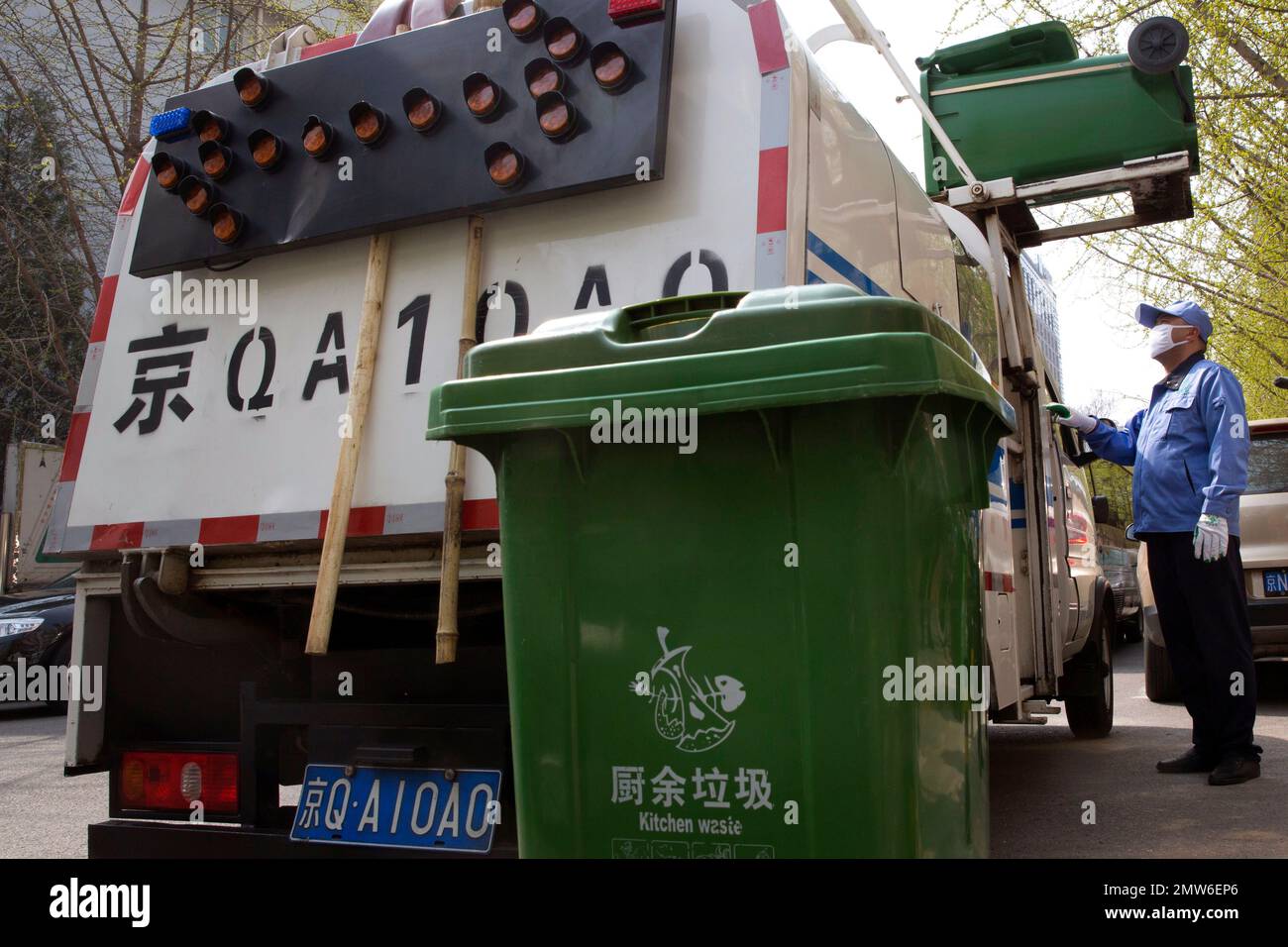 A worker collects kitchen waste from a community that practices garbage ...