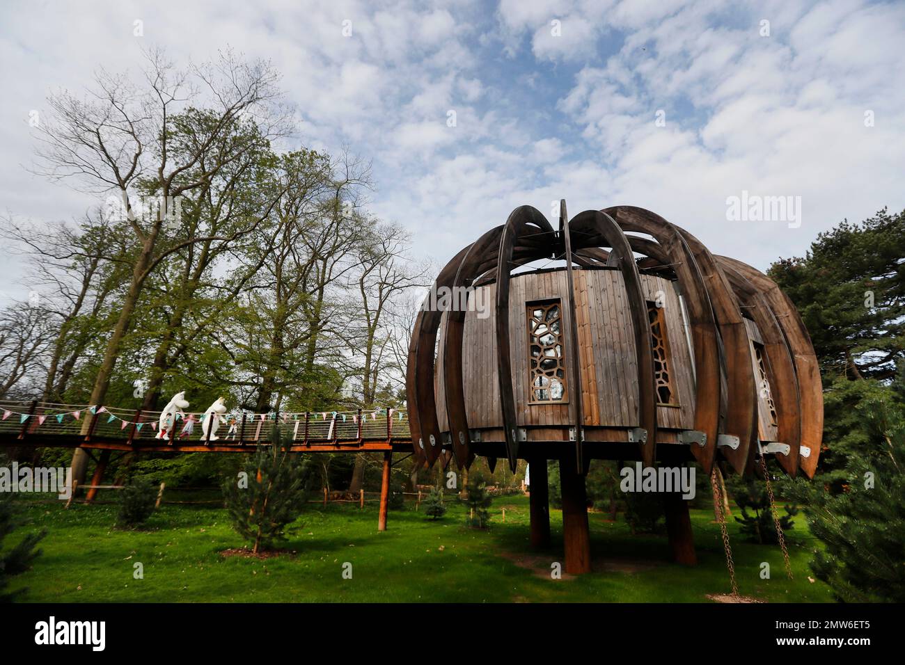 Children walk with Moomins up to a wooden tree house at Kew Gardens in ...