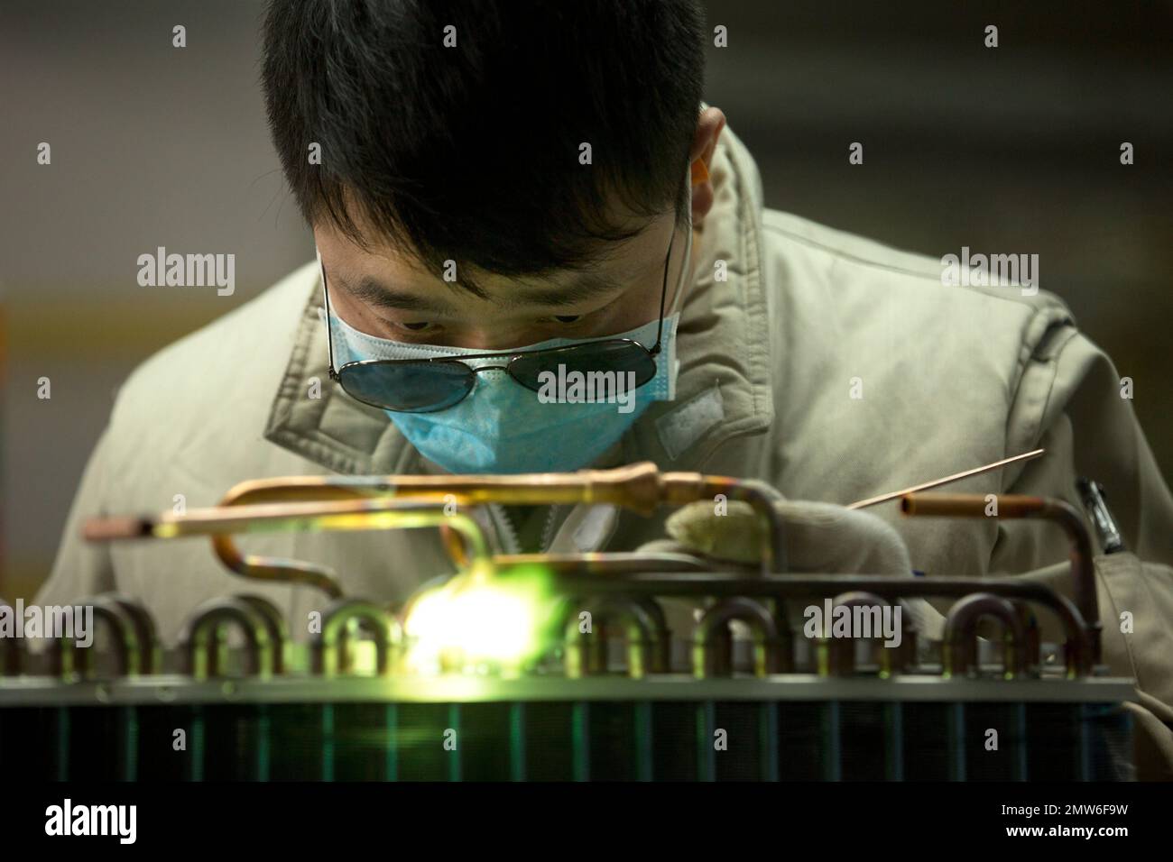 In this Friday, Feb. 24, 2017 photo, a factory worker uses a gas torch ...