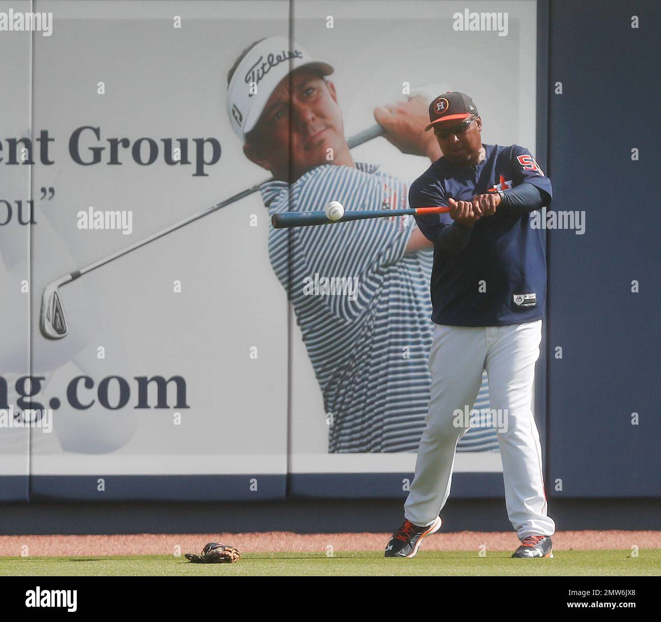 Houston Astros assistant hitting coach Alonzo Powell hits fly balls to ...