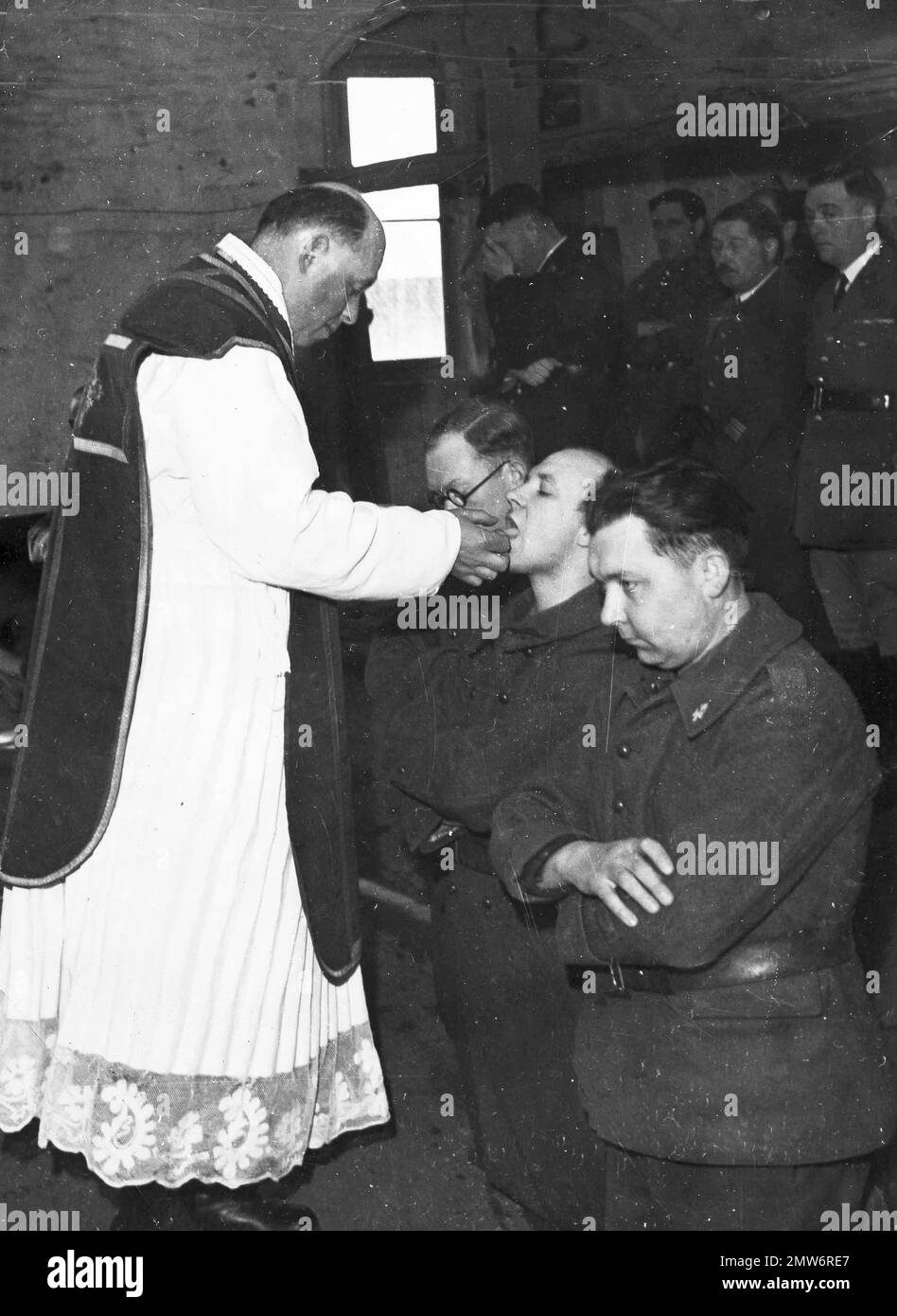 A priest celebrates Sunday Mass and gives Communion in the attic of a ...