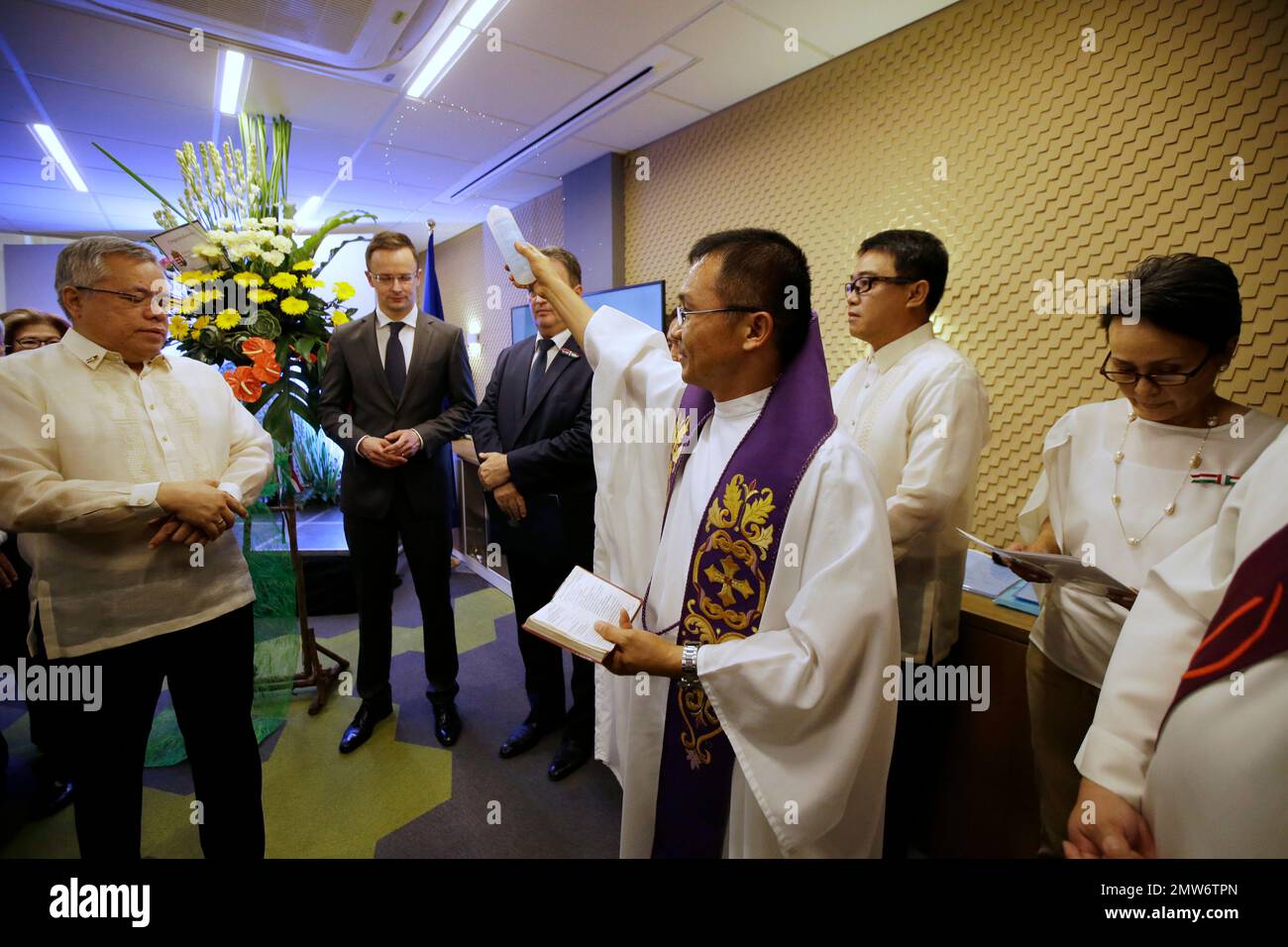 A Filipino Catholic priest blesses the Hungarian Embassy as Hungary ...
