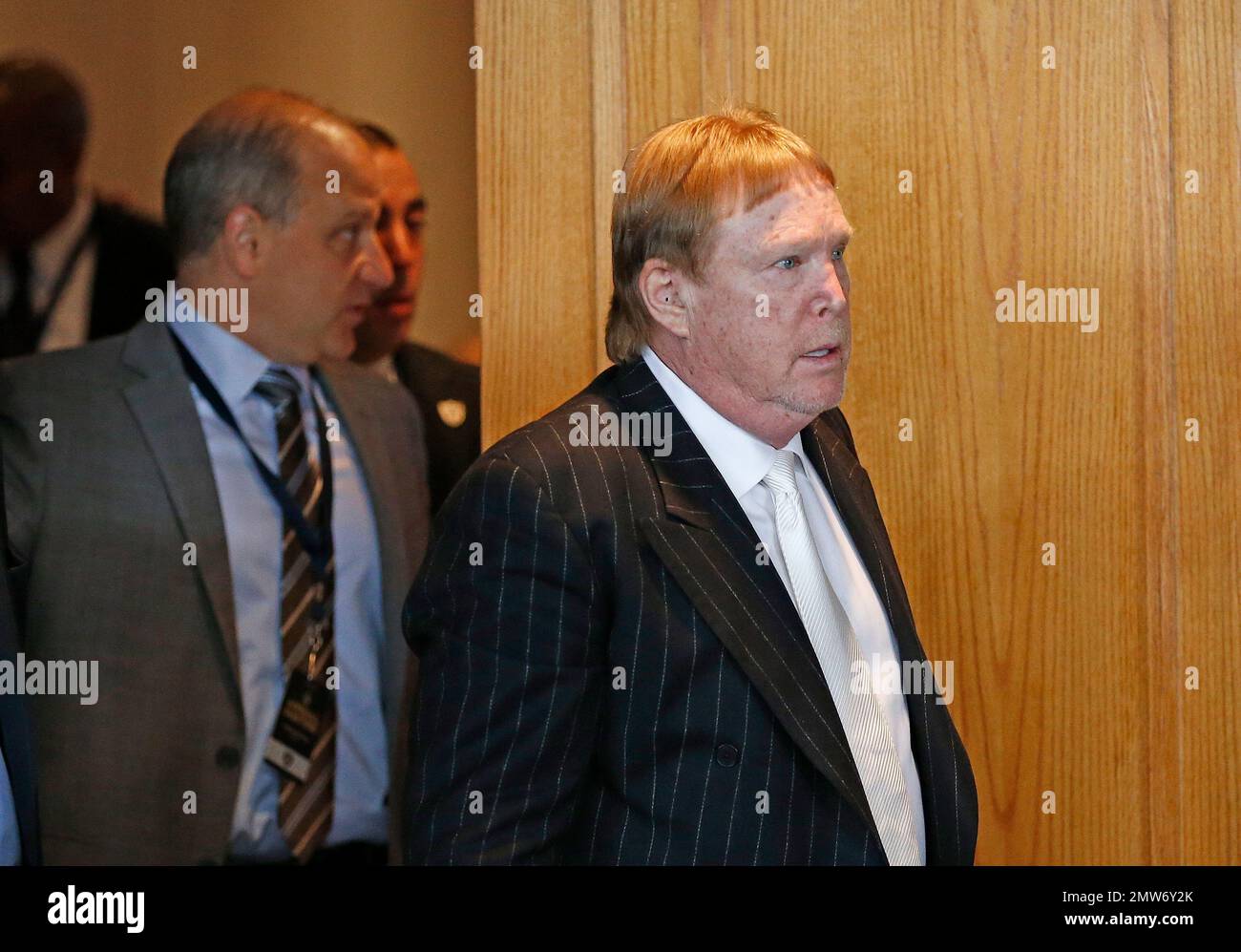 Oakland Raiders owner Mark Davis, right, emerges from the NFL football ...