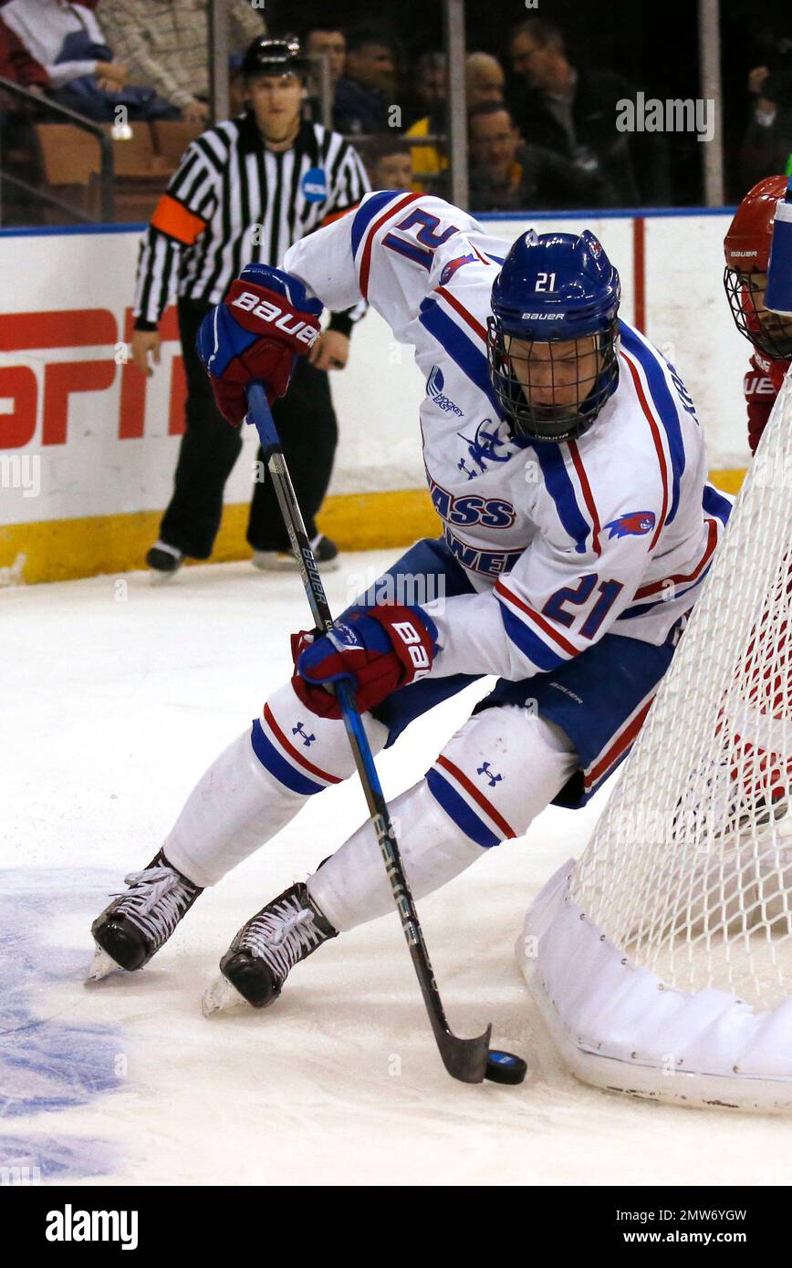 UMass Lowell's Jake Kamrass (21) controls the puck behind the net ...
