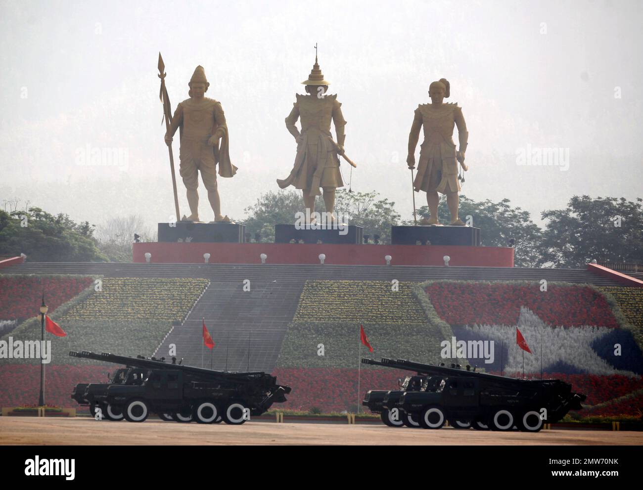 Myanmar military soldiers salute from vehicles carrying rockets as they ...