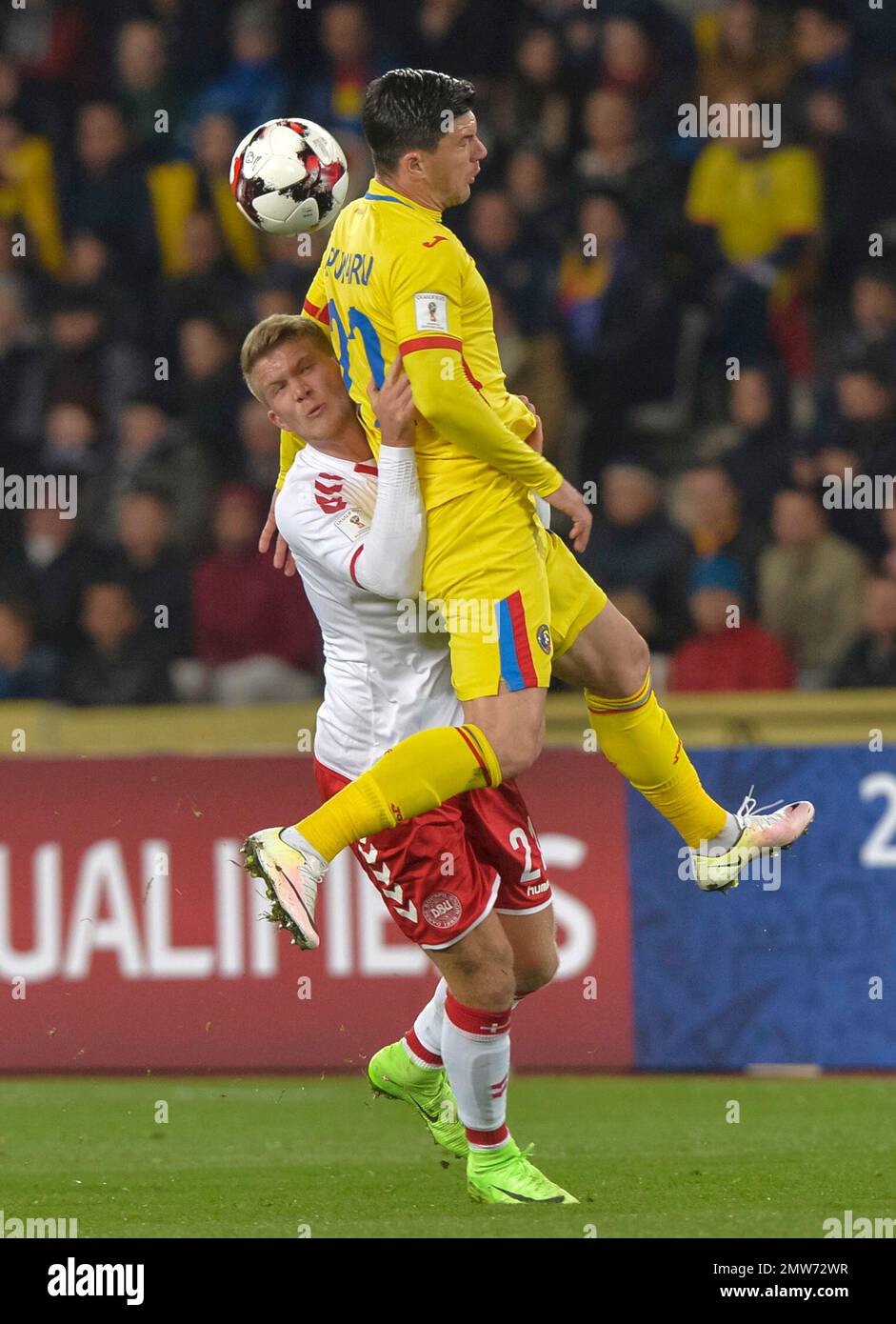 Denmark's Andreas Cornelius, left, challenges Romania's Cristian ...