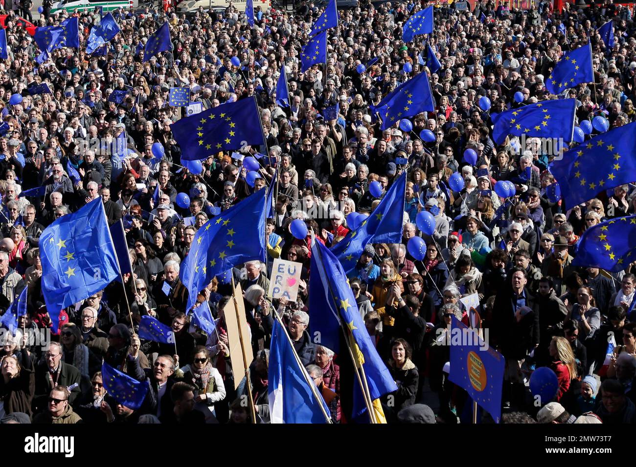 Supporters wave European flags during a rally of the Pulse of Europe ...