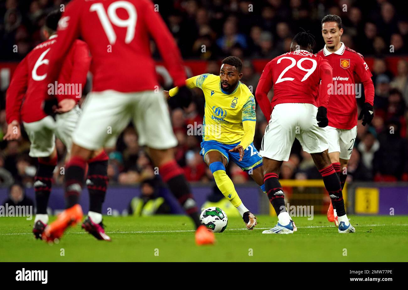 Nottingham Forest's Emmanuel Dennis is closed down by the Manchester ...