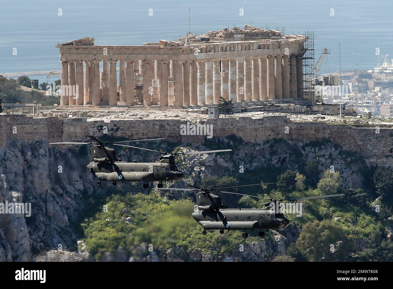 Chinook helicopters fly in front of the temple of the Parthenon, on the ...