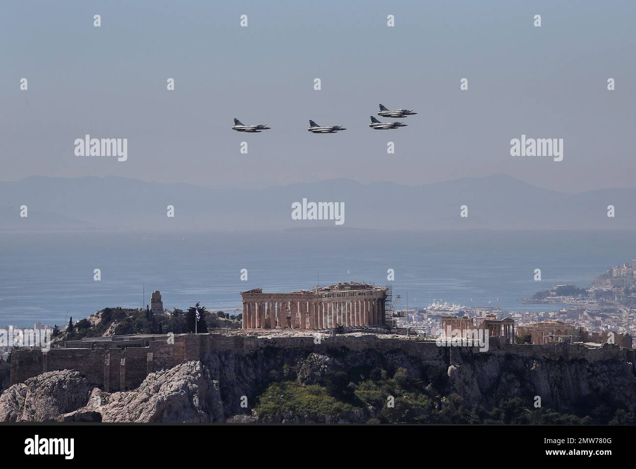 A formation of Greek fighter jets flies over the temple of the ...