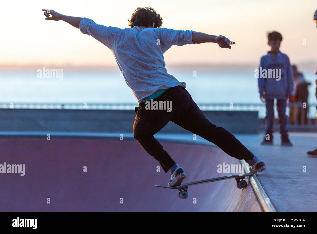 young man riding skateboard in a skatepark Stock Photo - Alamy