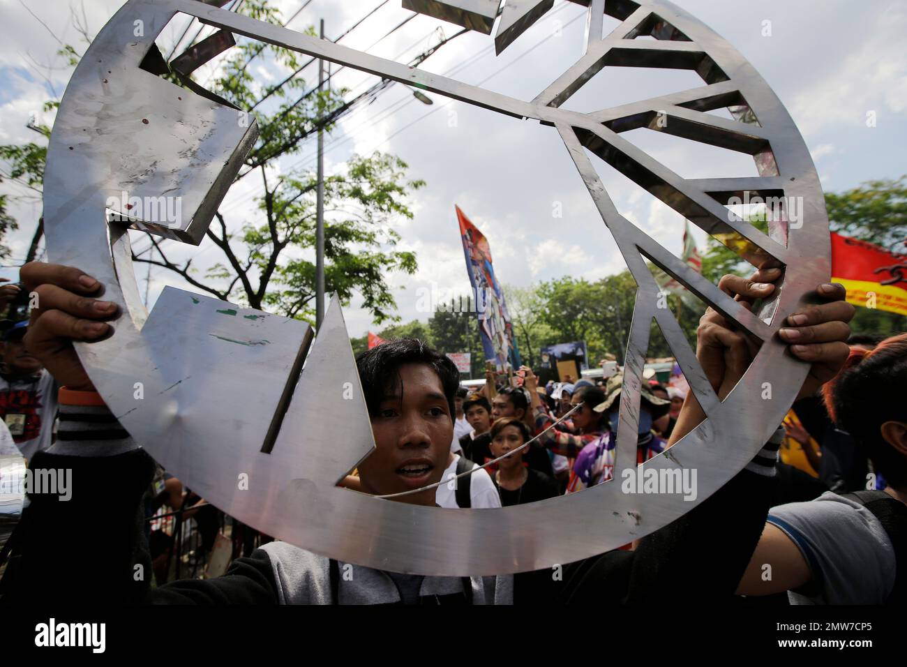 A protester holds the logo of the National Housing Authority office ...