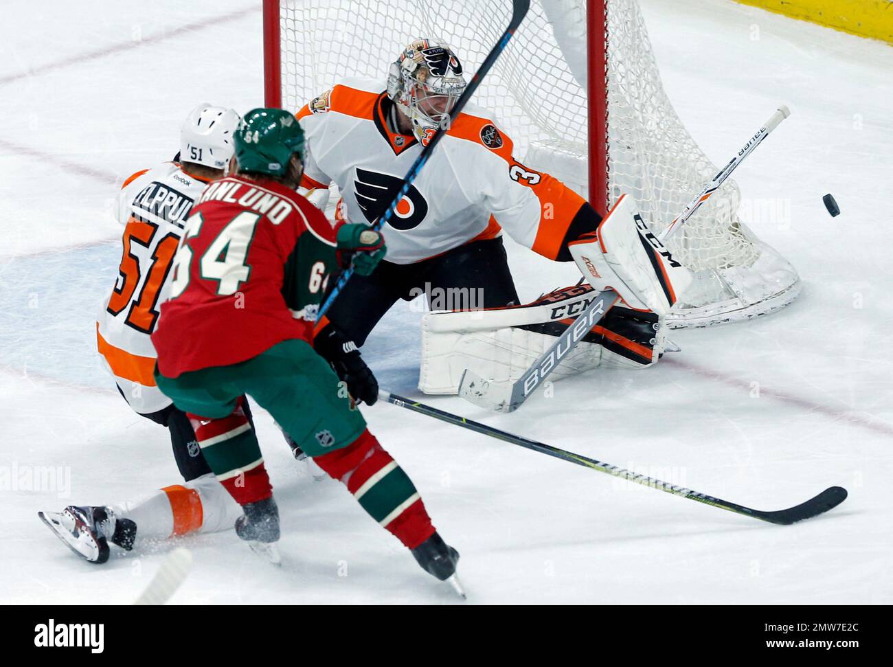 Philadelphia Flyers goalie Steve Mason, right, deflects a shot by ...
