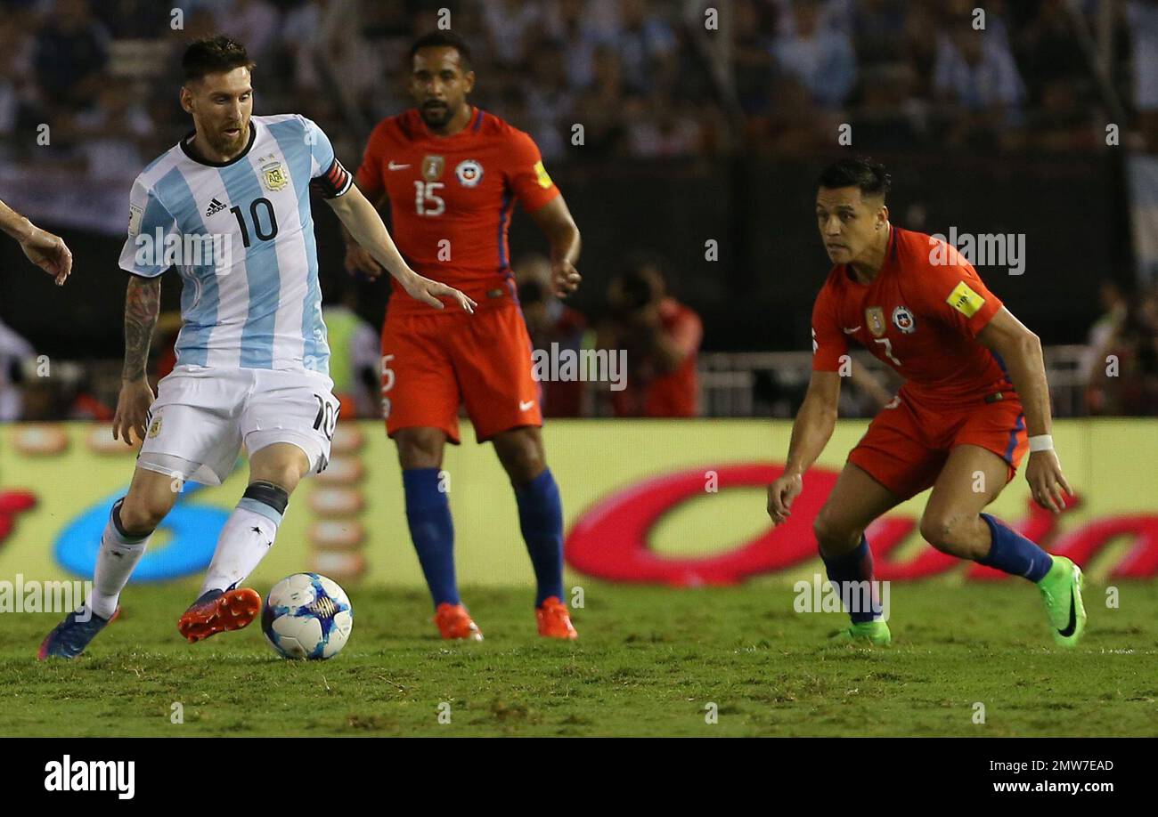 Argentina’s Lionel Messi, left, controls the ball as Chile’s Alexis ...