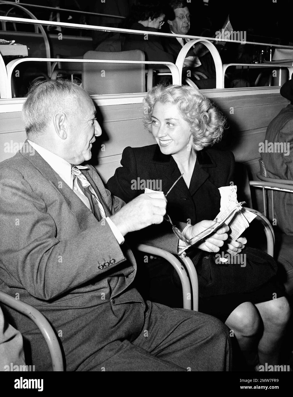 Joan Blondell, of the screen, smiles broadly as producer Joseph Schenck ...