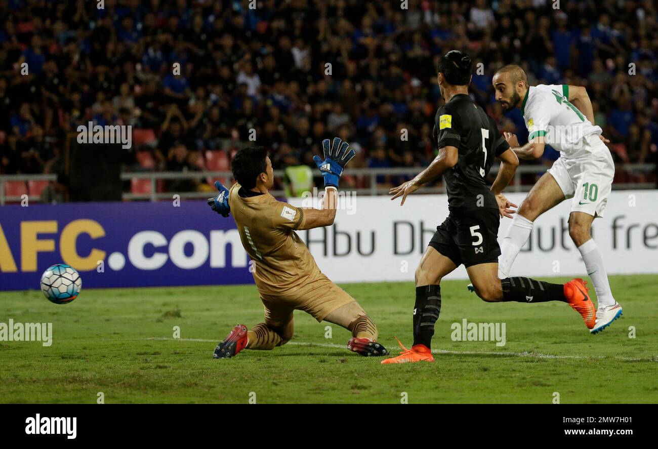 Mohammad Al-Sahlawi of Saudi Arabia, right, shoots to score during ...