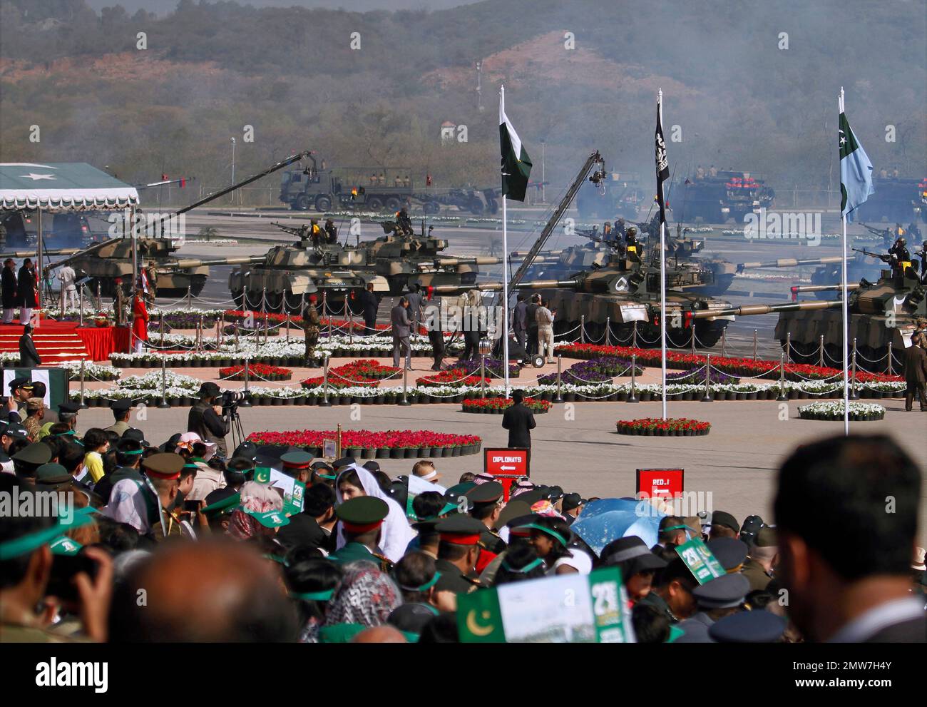 People watch Pakistani army tanks during a military parade to mark ...