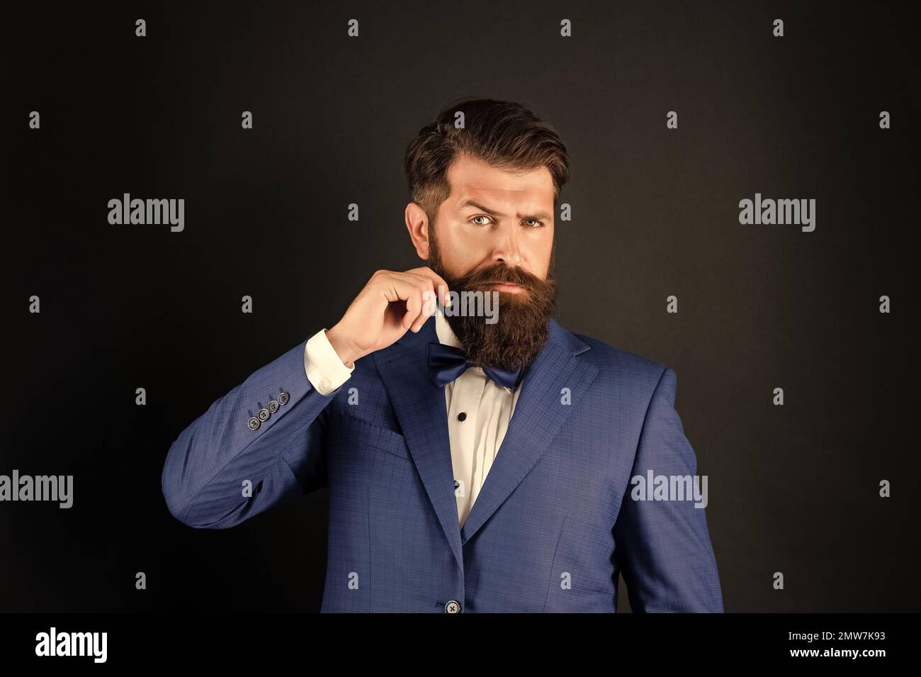 serious rich man in tuxedo bow tie. man in formalwear on black ...