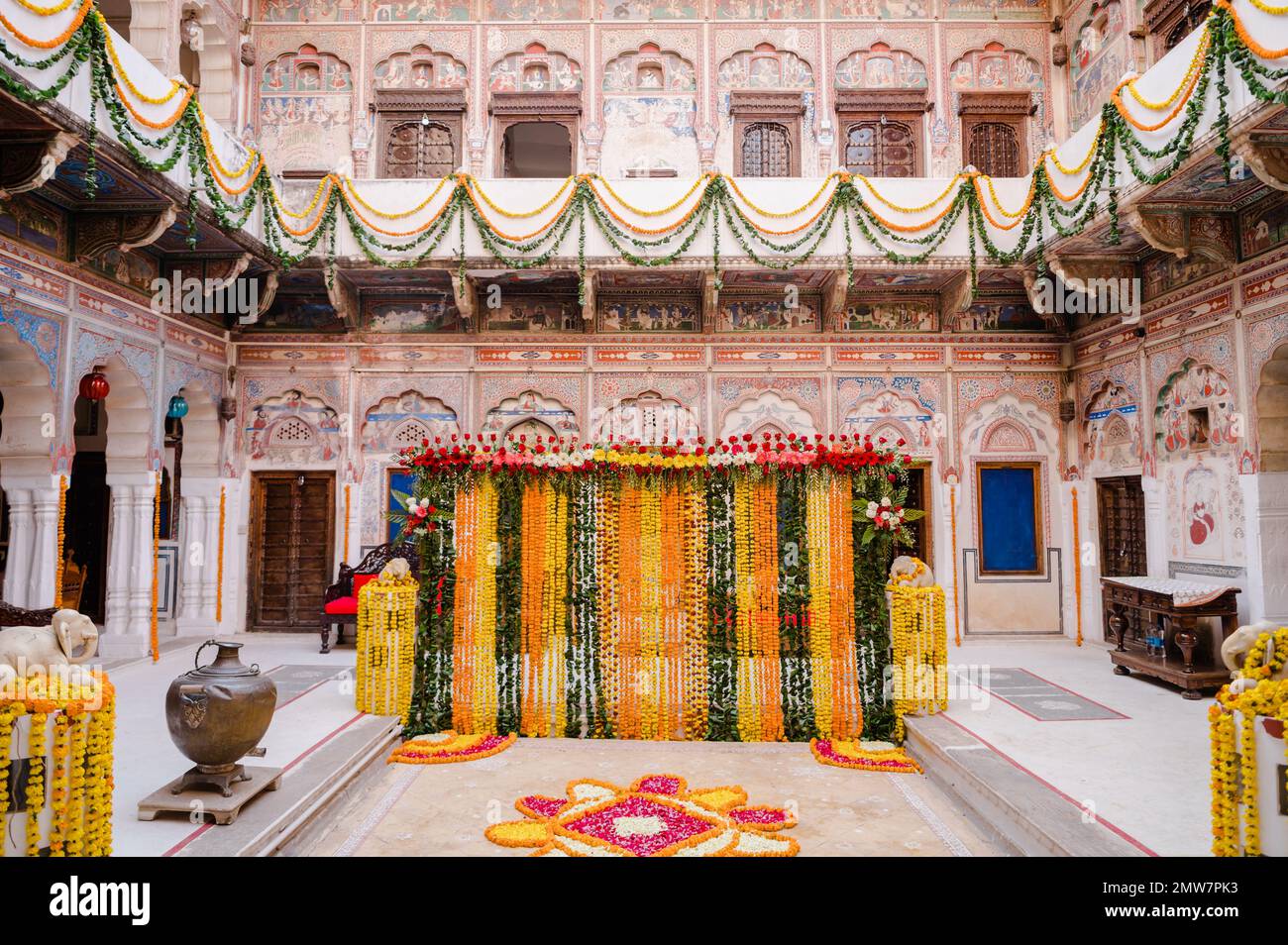 An interior of e temple decorated with colorful flower garlands and ...