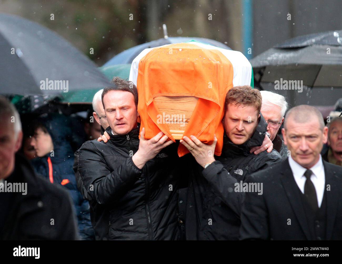 Emmett and Fiachra McGuinness carry the coffin of their father Martin ...