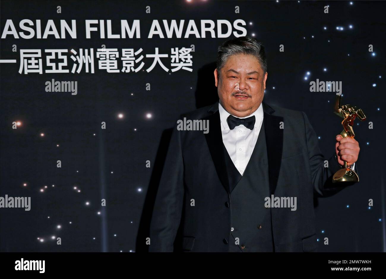 Hong Kong actor Lam Suet poses after winning the Best Supporting Actor ...
