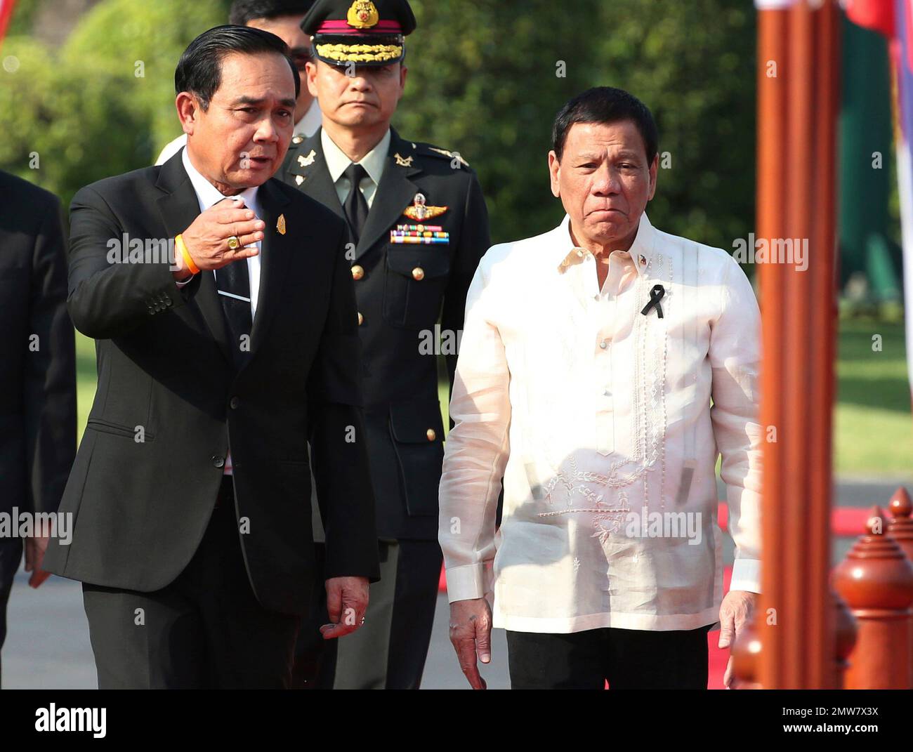 Philippine President Rodrigo Duterte, right, is shown the way by ...