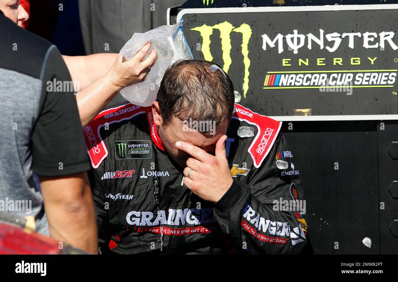 An exhausted Ryan Newman sits in victory lane with an ice pack on his ...