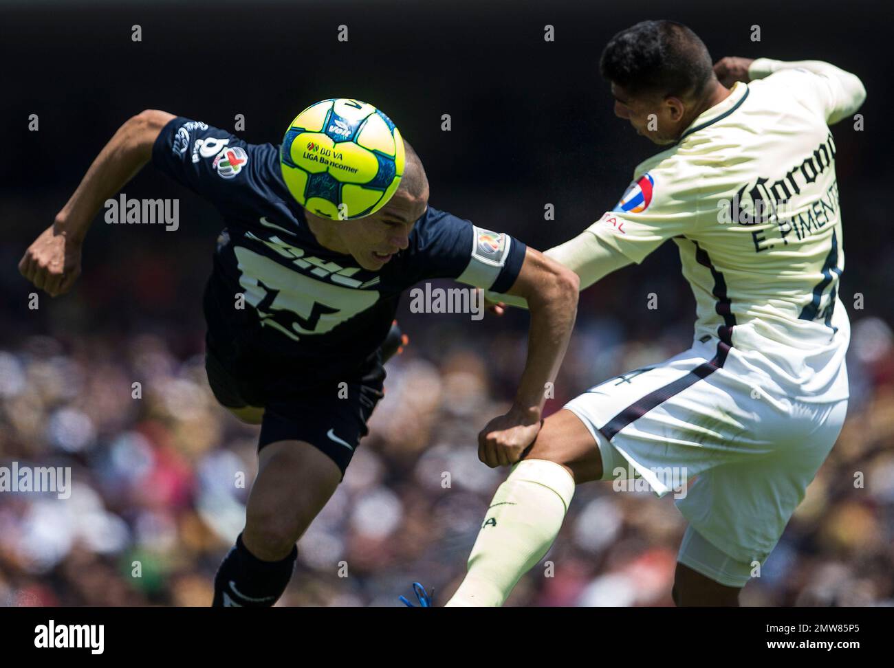Puma's Dario Veron, left, heads the ball next to America's Erik ...
