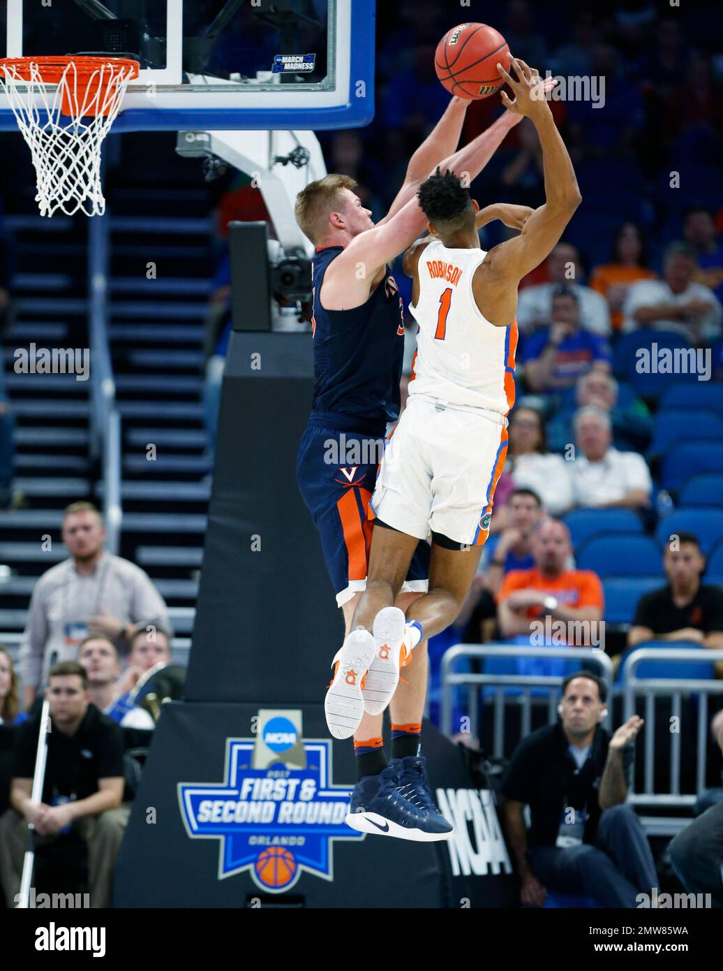 Virginia center Jack Salt, left, blocks a shot from Florida forward ...