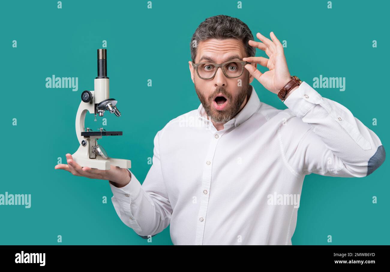 surprised man with invention microscope isolated on blue background ...