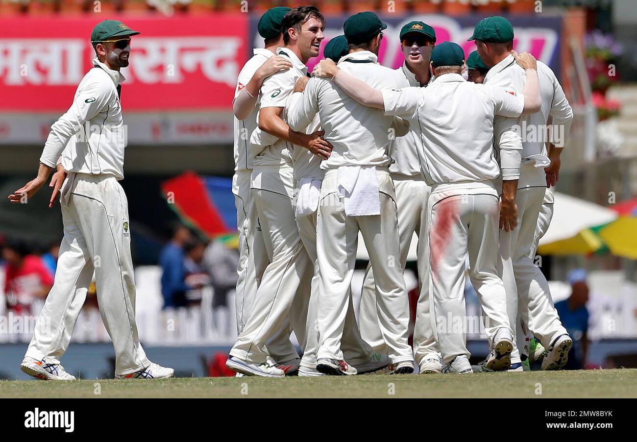Australia's Pat Cummins, without cap, celebrates with teammates the ...