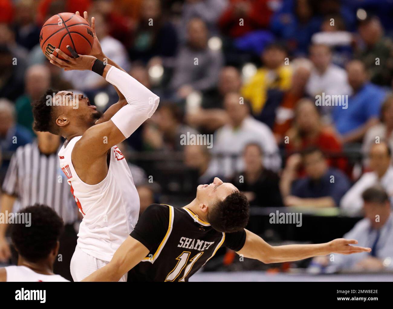 Dayton's Charles Cooke, left, shoots as Wichita State's Landry Shamet ...