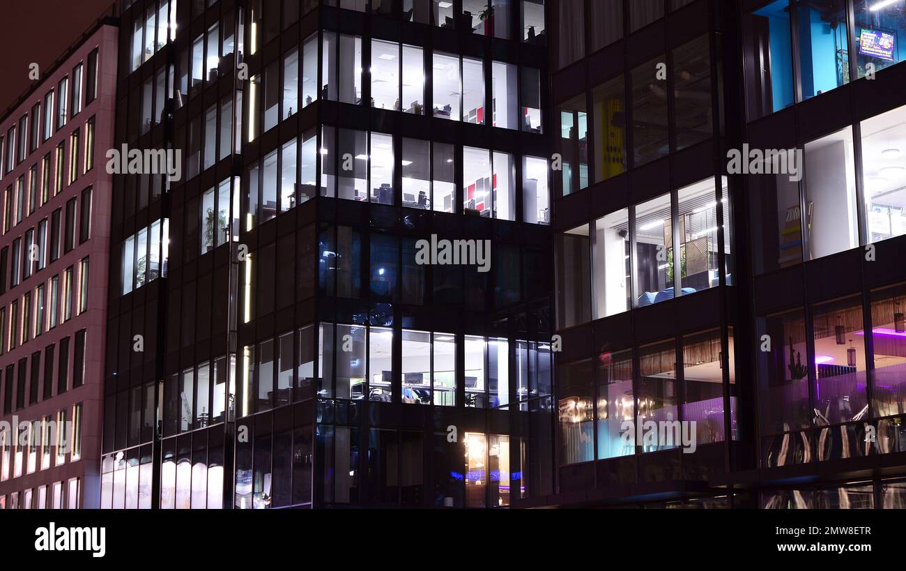 Corporate building at night - business concept. Glass wall office ...