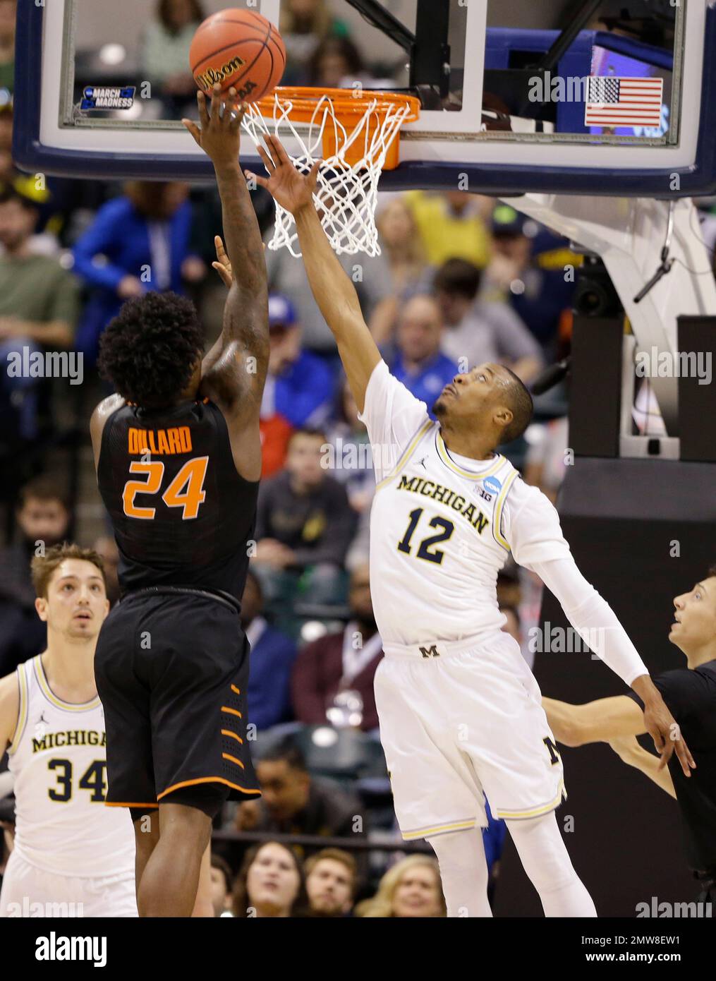 Oklahoma State guard Davon Dillard (24) shoot dover Michigan guard ...