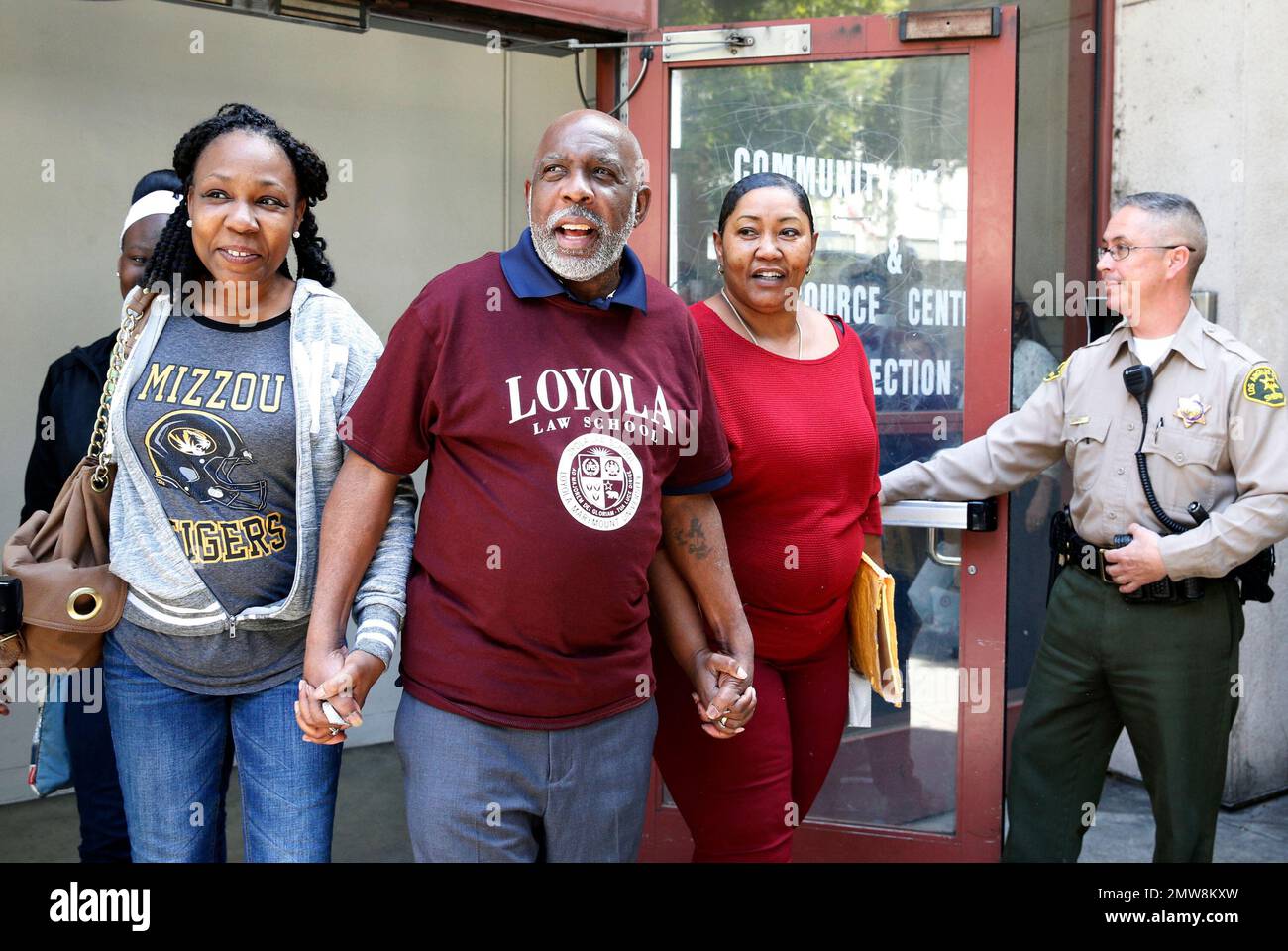 Andrew Wilson, center, is accompanied by his daughters, Catrina Burks ...