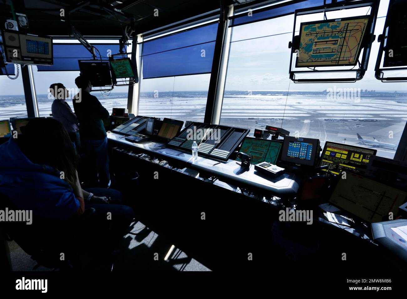 Air traffic controllers work in the tower at John F. Kennedy ...