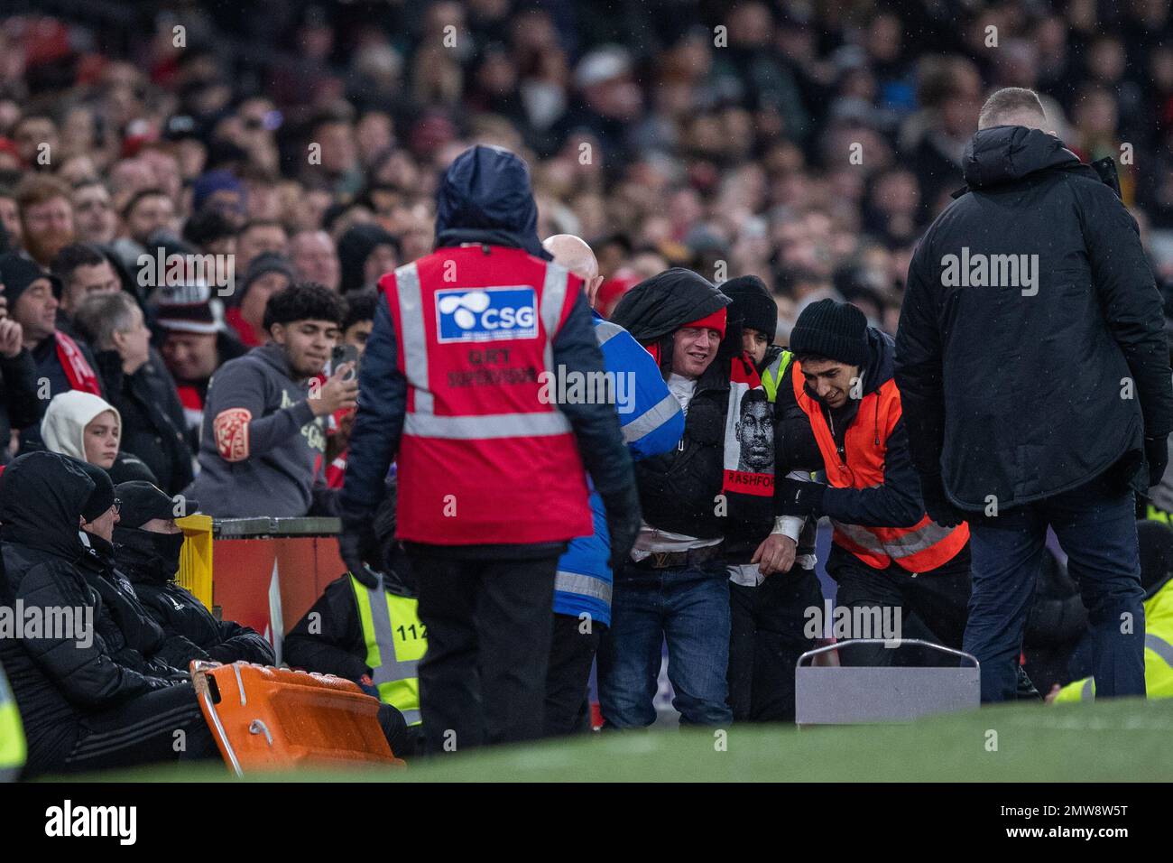 A pitch invader is caught close to the touchline during the Carabao Cup ...