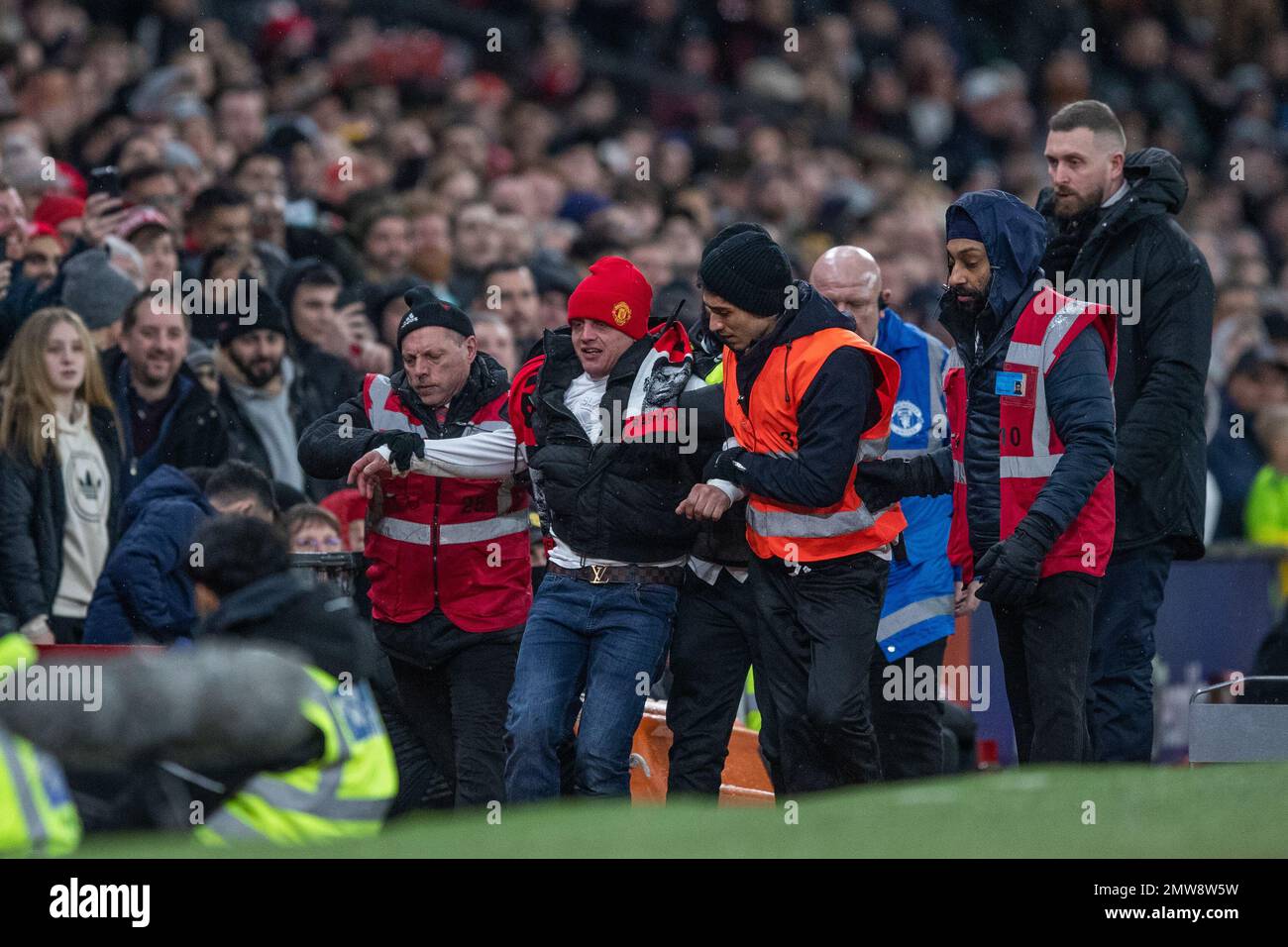 A pitch invader is caught close to the touchline during the Carabao Cup ...