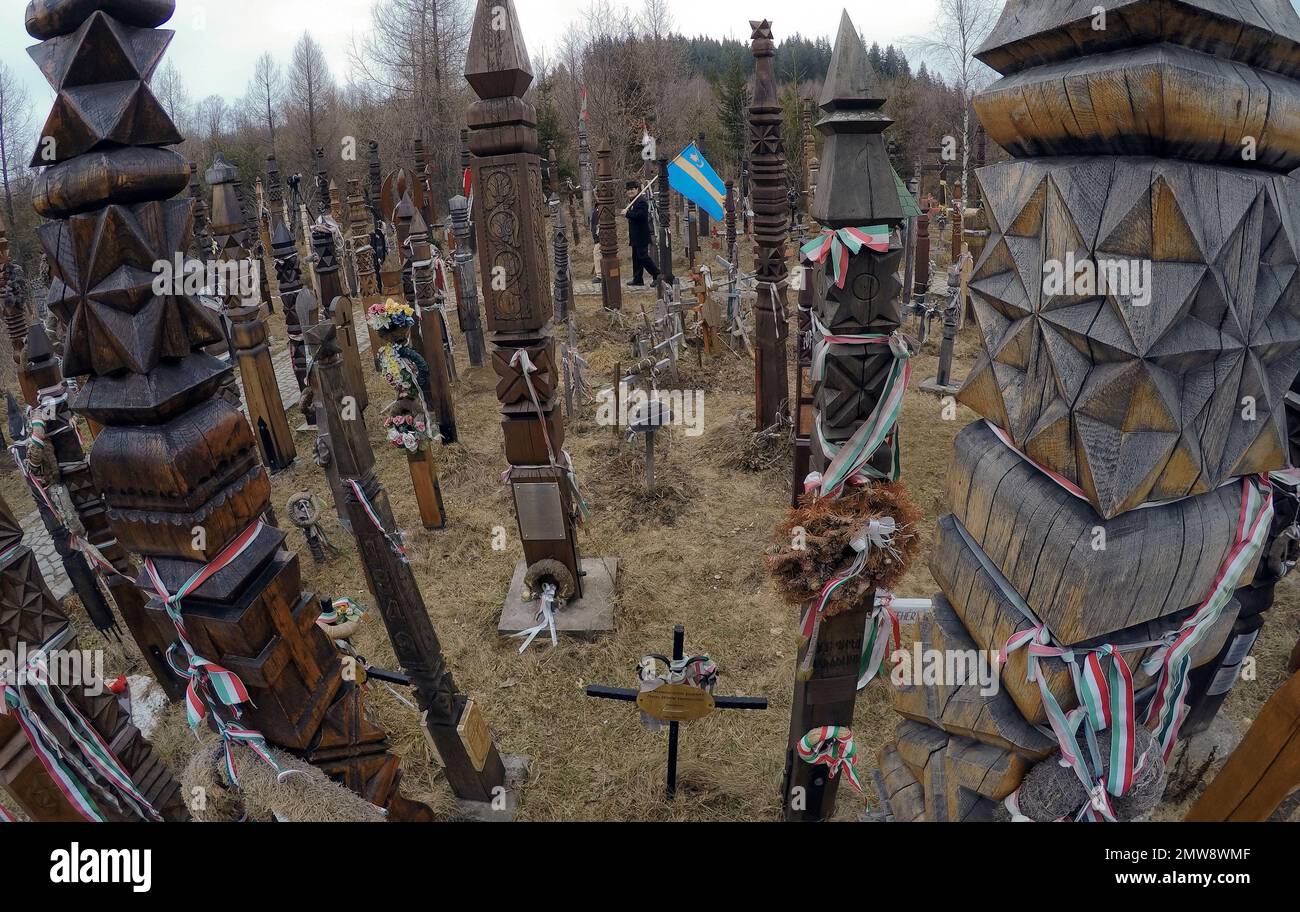 A man walks in a cemetery for the Szeklers, ethnic Hungarians living in ...