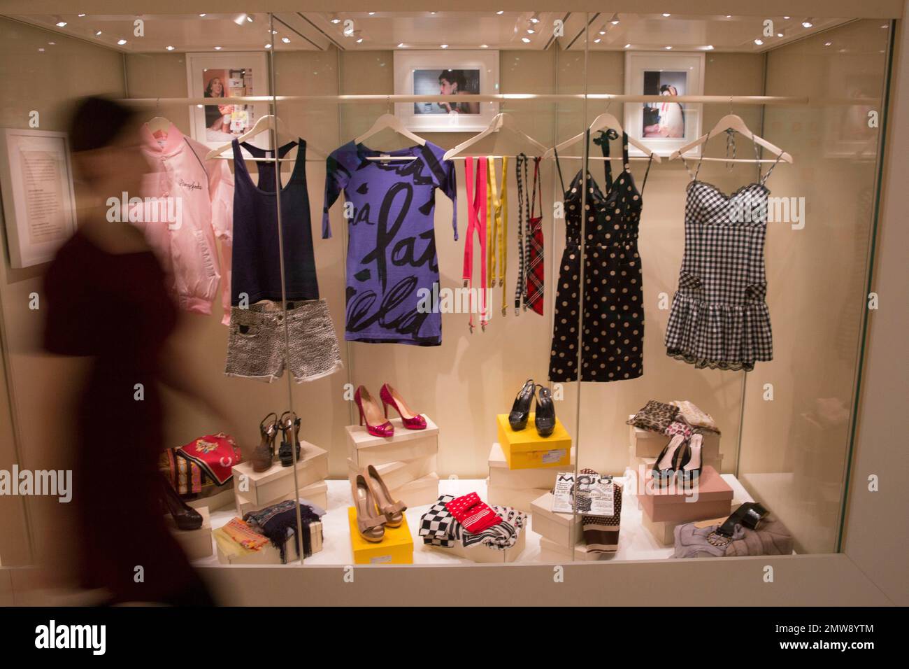 Hannah Talbot walks past items of clothing worn by musician Amy ...